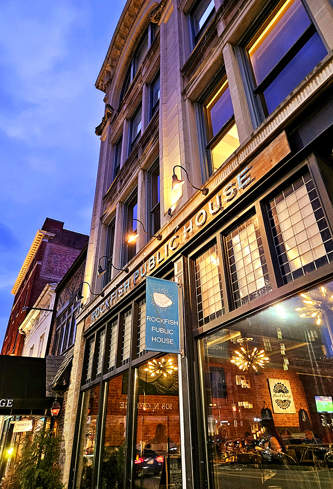 Evening light transforms Rockfish's historic facade into something magical&mdash;brick, glass, and seafood dreams.