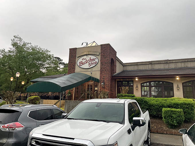 The Butcher Shop's classic brick exterior and green awning promise no-nonsense steak excellence inside.