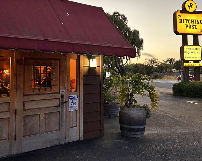 The Hitching Post's humble entrance with wooden barrel planters feels like discovering a local secret, even after Hollywood put it on the map.