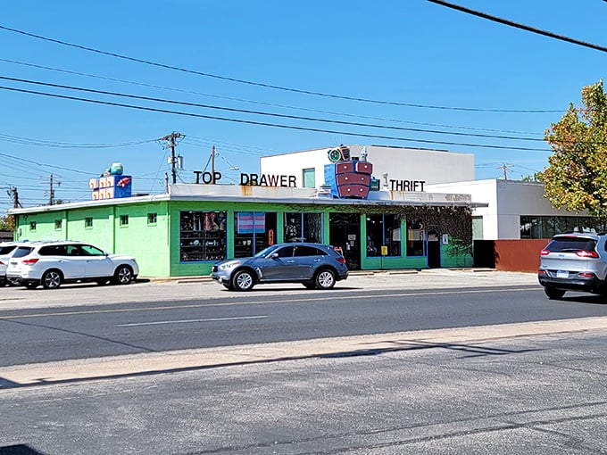 Top Drawer's charming green storefront with its quirky dresser logo promises a thrifting experience with personality.
