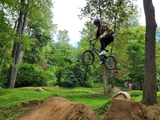 An airborne moment at Apple Creek's bike trails. Gravity is just a suggestion when you've got skills and a perfectly built jump.