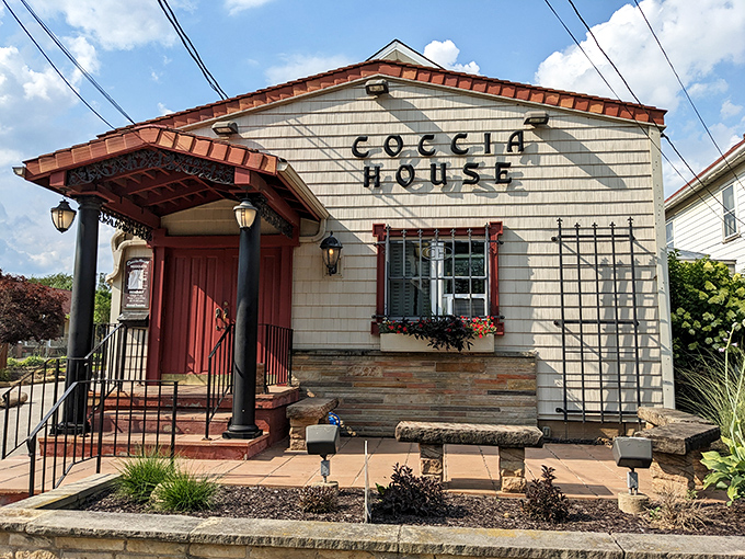 That charming red door at Coccia House is the gateway to some of Ohio's most beloved thick-crust pizza.