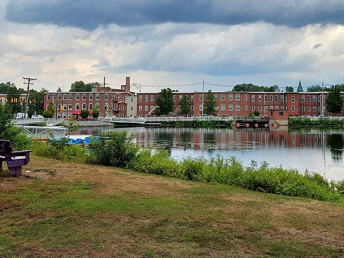 Admire the scenic waterfront of Easthampton as you look across the water toward historic brick buildings under a dramatic sky.
