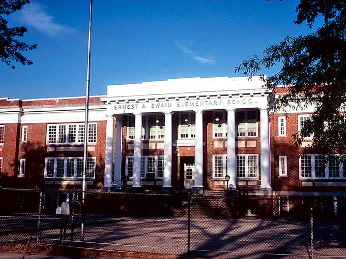 This tree-lined street whispers of quieter times when neighbors knew each other and life moved at walking pace.