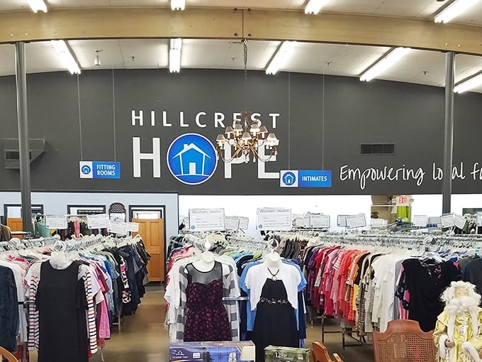 Inside Hillcrest Hope, clothing racks stretch toward the horizon. The "Empowering" sign says it all&mdash;thrifting with purpose!