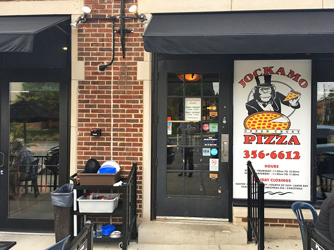 Brick facade, black awnings, and a primate with pizza&mdash;Jockamo's exterior design choices are as confident and distinctive as their Upper Crust pies.