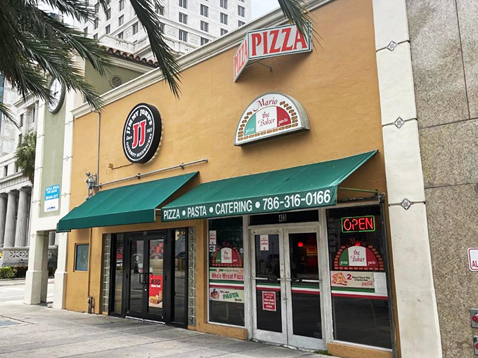 The simple green awning at Mario's hides decades of pizza perfection that keeps Miami coming back for "just one more slice."