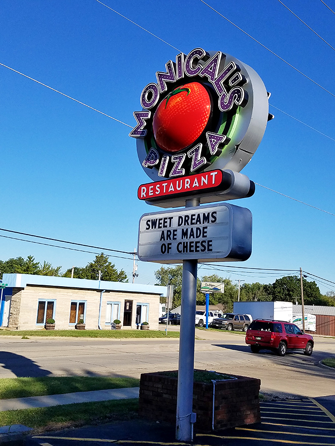 Monical's illuminated tomato sign shines like a pizza lighthouse, guiding hungry travelers to safe, delicious harbor.
