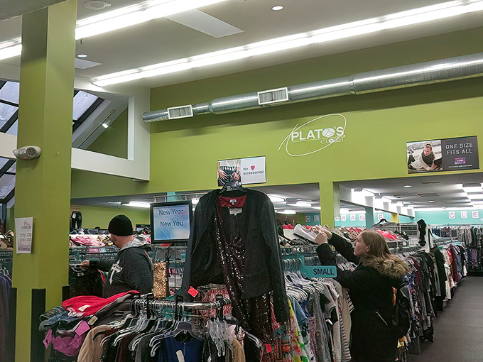 Inside Plato's Closet, the vibrant green walls frame an organized paradise of gently-used teen fashion waiting for its second act.