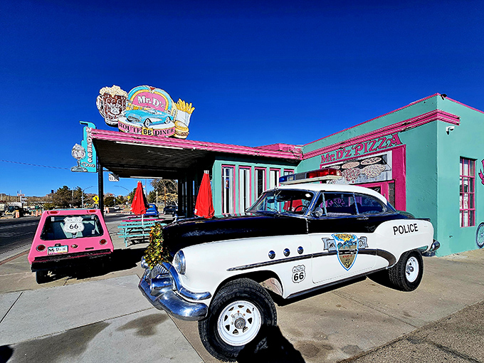 The turquoise and pink exterior of Mr. D'z isn't just a building&mdash;it's a time portal with vintage police cruiser standing guard.
