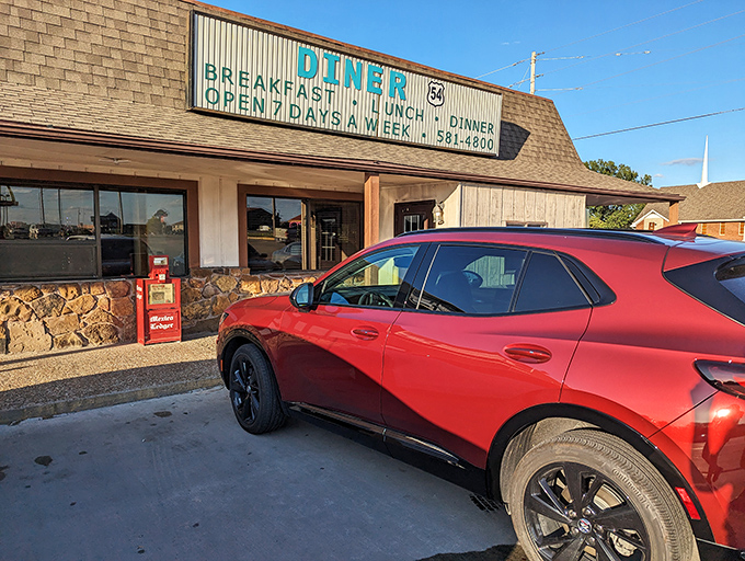 The classic roadside sign beckons hungry travelers like a lighthouse for the famished. Diner 54's unassuming exterior promises honest food without pretension.