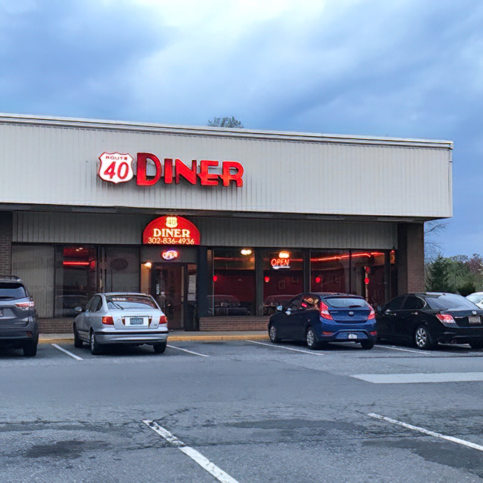 The bright red Route 40 Diner sign beckons hungry travelers like a lighthouse for the breakfast-starved. Classic Americana at its finest.