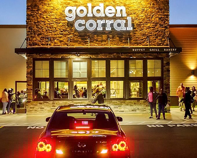 The Golden Corral's illuminated stone facade beckons hungry patrons like a Vegas-style beacon of buffet abundance, promising culinary adventures without the gambling.