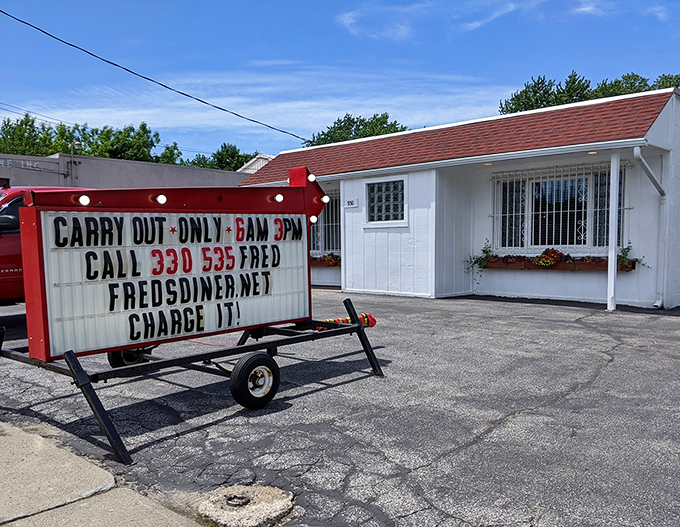 The unassuming white exterior of Fred's Diner proves once again that culinary treasures often hide in plain sight. Those flower boxes are your first clue to the warmth waiting inside.