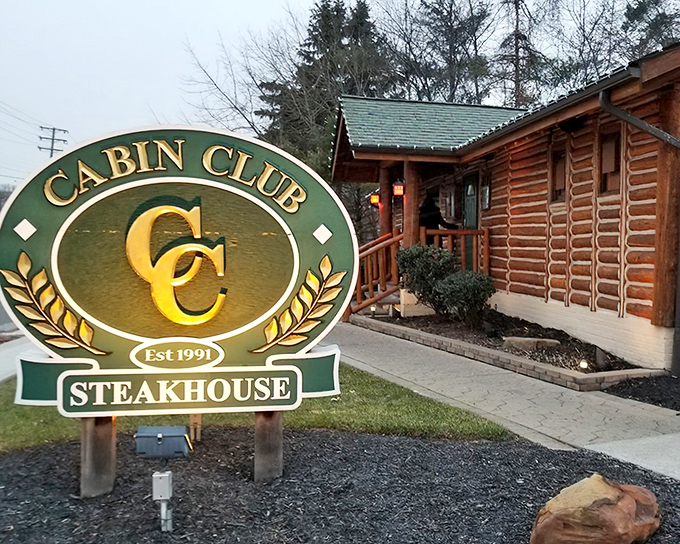 The rustic log cabin exterior of Cabin Club isn't just charming&mdash;it's a promise of the cozy, wood-scented culinary adventure waiting inside.