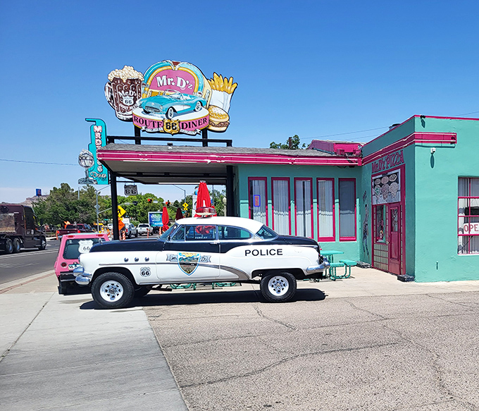 The turquoise and pink exterior of Mr. D'z isn't just a building&mdash;it's a time portal with vintage police cruiser standing guard.