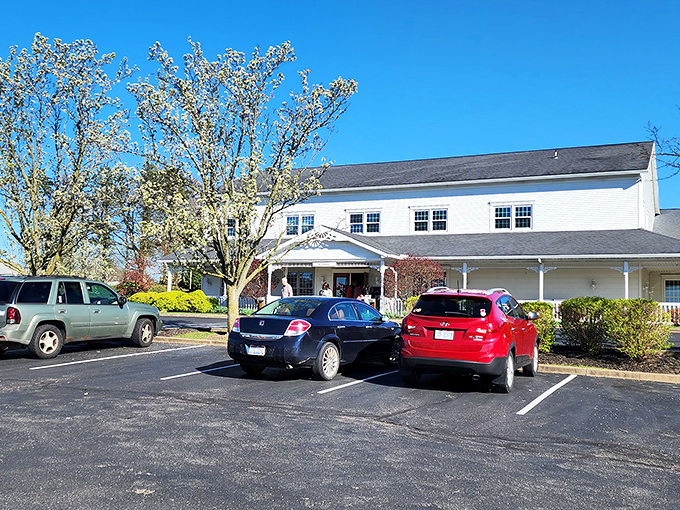 The classic white clapboard exterior of Amish Door Restaurant stands like a beacon of comfort food promise in Wilmot's rolling countryside.