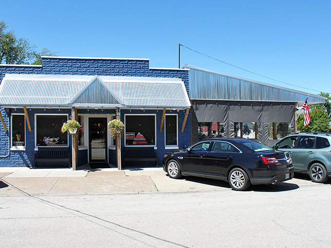Rustic charm meets lakeside comfort at Sparky's Place, where that wooden porch practically whispers, "Come on in, the food's waiting!"