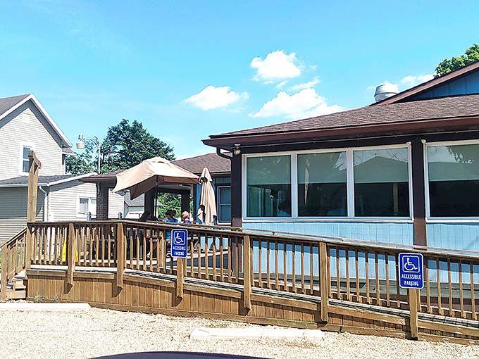 The blue exterior of Wedgewing Family Restaurant stands as a beacon of comfort food promise, complete with a wooden deck that practically whispers "come on in, stranger."