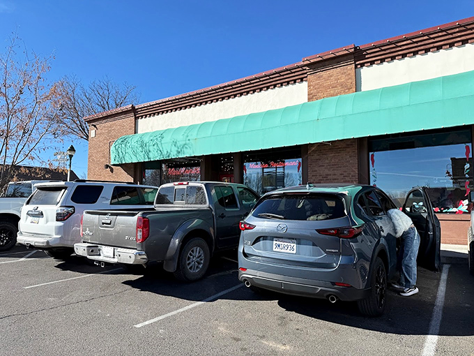 The unassuming exterior hides culinary treasures within. That turquoise awning is like a beacon calling hungry travelers home.