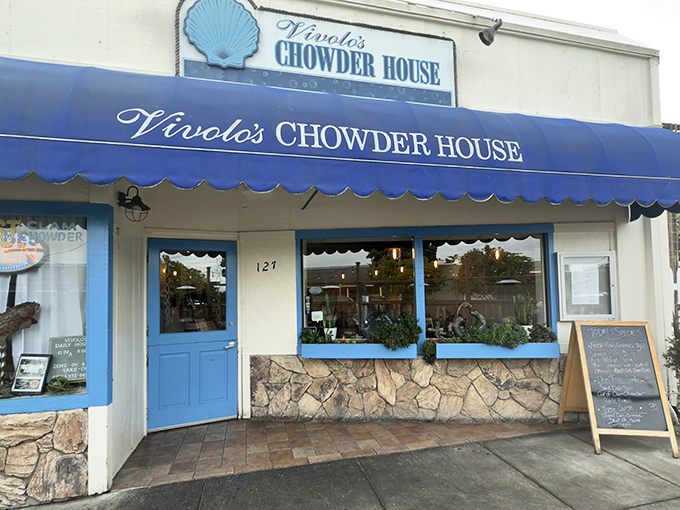 The iconic blue awning of Vivolo's stands out like a maritime flag, beckoning hungry travelers with the promise of chowder perfection.