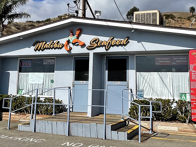 The unassuming white facade of Malibu Seafood, where that iconic red lobster sign has been beckoning seafood lovers off PCH for decades.