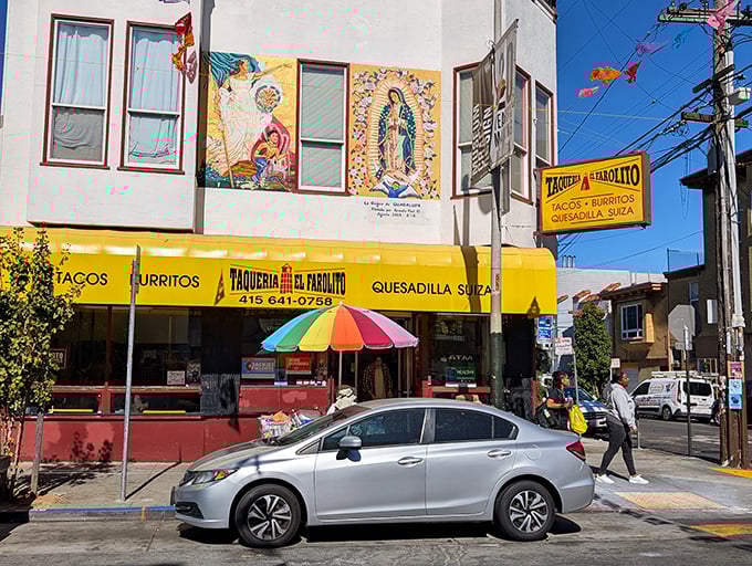 The iconic yellow awning of El Farolito stands out like a beacon of burrito hope, complete with colorful murals that set the perfect stage.