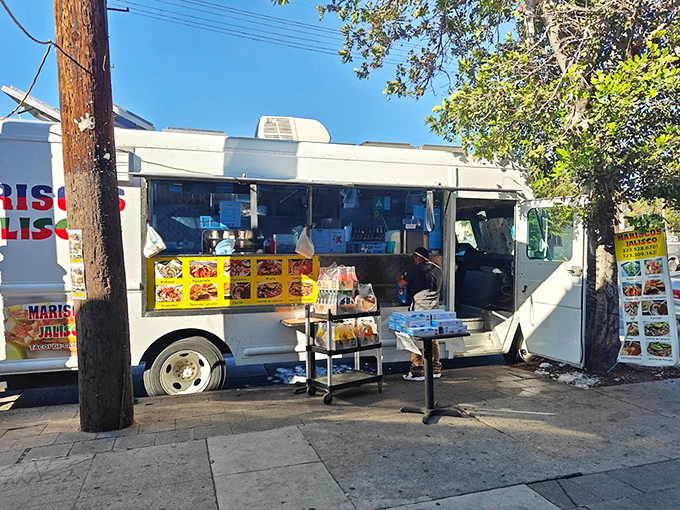 The unassuming white truck with bold red and green lettering houses culinary treasures that have locals lining up daily. Seafood nirvana awaits!