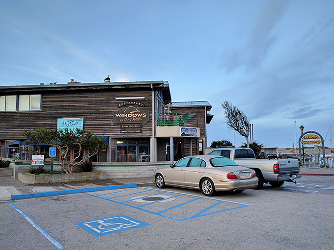 The weathered wooden exterior of Windows on the Water stands like a sentry guarding culinary treasures, its sign promising both views and victuals worth the journey.