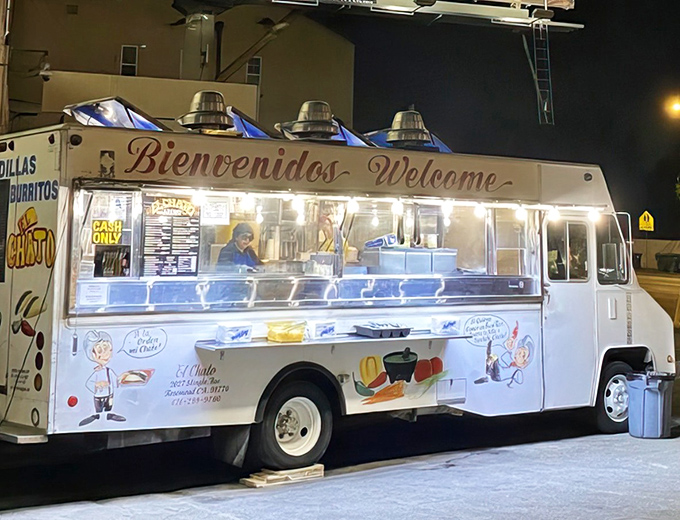 The glowing "Bienvenidos" sign on this unassuming white truck promises more culinary joy than most five-star restaurants could ever deliver.