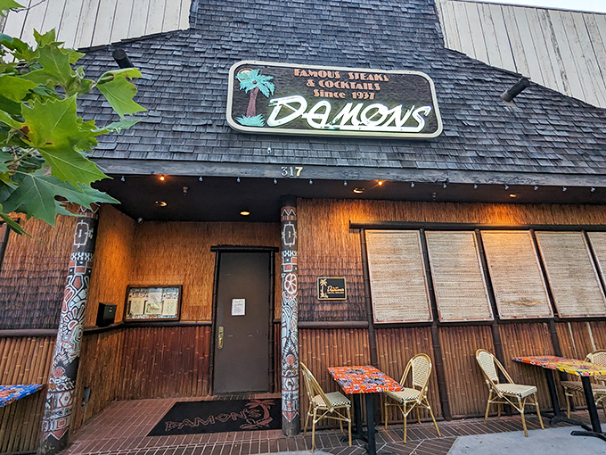 The A-frame entrance to Damon's beckons like a tiki temple in suburbia, promising tropical escape with every perfectly grilled steak.