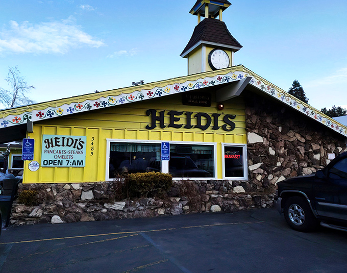 The Swiss chalet of breakfast dreams! Heidi's sunny yellow exterior with stone accents and charming clock tower promises Alpine comfort food that's worth the journey.