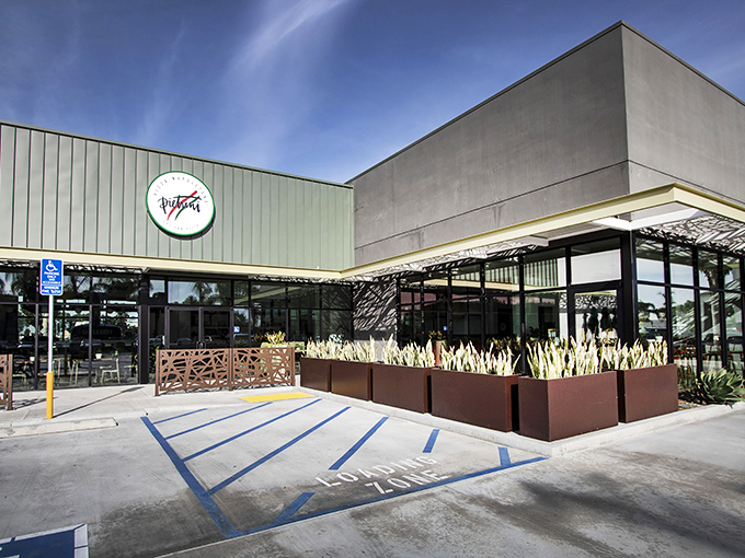 The unassuming exterior of Pietrini Pizza Napoletana proves once again that California's best culinary treasures often hide in plain sight, surrounded by pampas grass and promise.