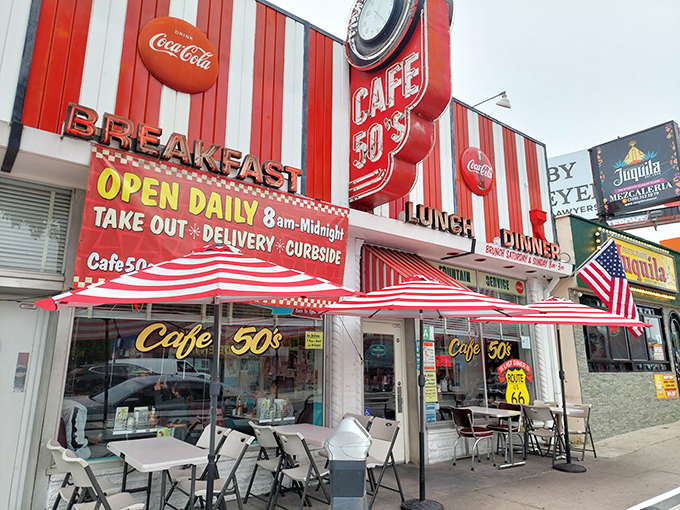 The time machine disguised as a diner. Cafe 50's vibrant red and white striped exterior beckons with promises of nostalgic delights and all-day breakfast.