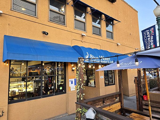 The iconic blue awning beckons seafood lovers like a maritime lighthouse. Simple stucco exterior hides culinary treasures that have San Diegans lining up daily.