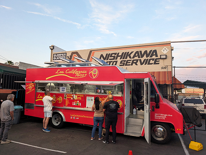 The bright red beacon of Los California Tacos stands proudly outside Nishikawa Auto Service, proving that culinary magic can happen in the most unexpected places.