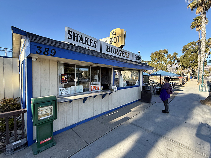 The blue-trimmed time capsule stands defiantly against modern dining trends, promising burgers that remember when flavor mattered more than Instagram appeal.