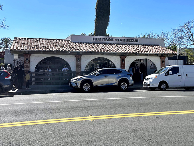 The pilgrimage begins here: Heritage Barbecue's modest Spanish-style exterior belies the smoky treasures within. Yellow bollards guide the faithful.