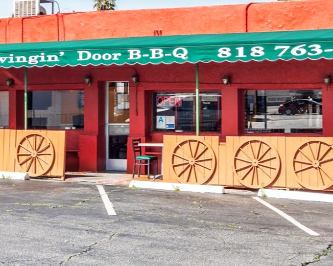 The bright red exterior with wagon wheel accents isn't just eye-catching&mdash;it's a smoke signal to BBQ lovers that authentic Texas flavor awaits inside.