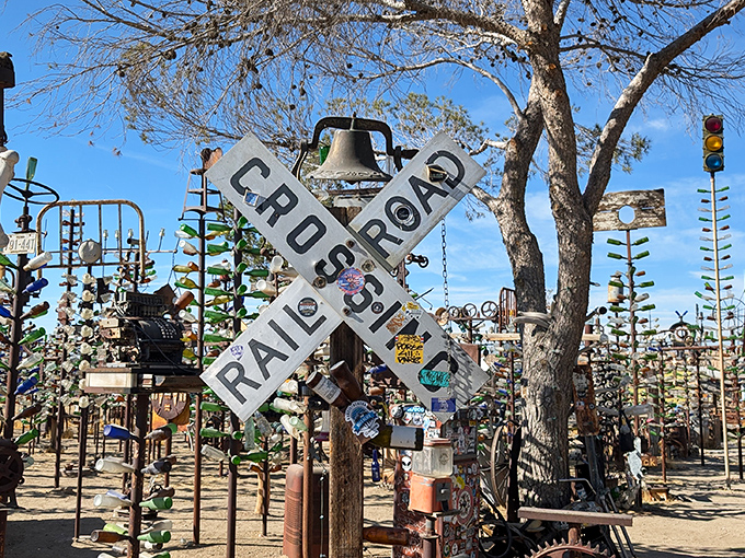 Where Route 66 meets artistic genius! This railroad crossing sign stands sentinel among a forest of glittering glass, like a traffic cop directing dreams.