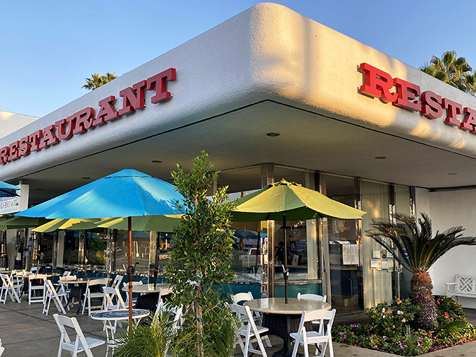 Mid-century modern meets palm tree paradise at this North Hills gem. The outdoor patio beckons with blue umbrellas and California sunshine.