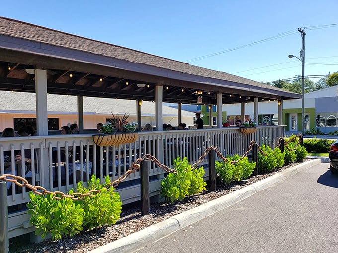 The welcoming porch at Trip's Diner invites you in like an old friend, with lush greenery and the promise of comfort food just steps away.