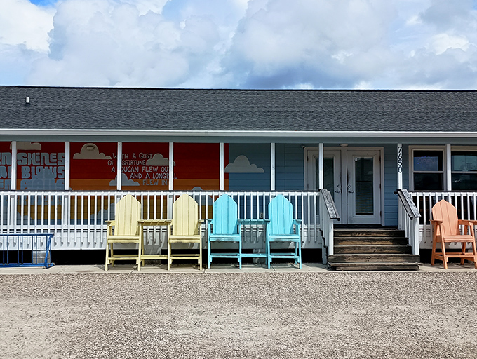 LongBill's cheerful blue exterior with its vibrant sunset mural practically screams "vacation mode activated!" The colorful Adirondack chairs are just waiting for you.