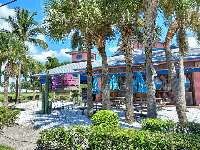 The pink exterior of The Lazy Flamingo isn't just a building&mdash;it's a promise of Florida fun that delivers every time. Classic cars and palm trees complete the postcard-perfect scene.