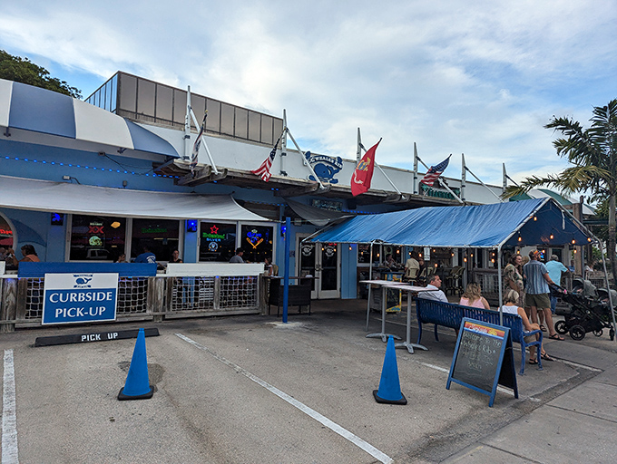 The blue-hued exterior of The Whale's Rib stands like a maritime beacon for hungry beachgoers, complete with nautical flags that practically scream "fresh seafood inside!"