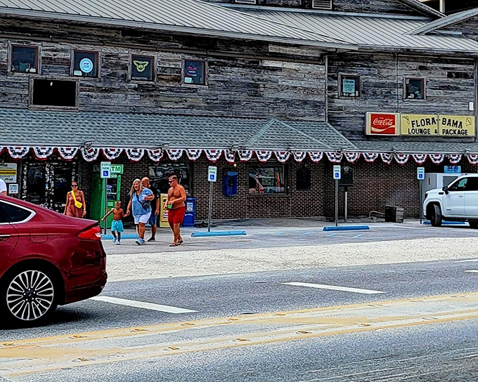 The weathered wooden exterior of Flora-Bama tells stories that no Instagram filter could ever capture. State-line straddling never looked so inviting!