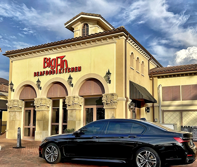 Mediterranean elegance meets Florida flair at Big Fin's inviting entrance. The warm lighting and arched doorways promise seafood adventures beyond the ordinary.
