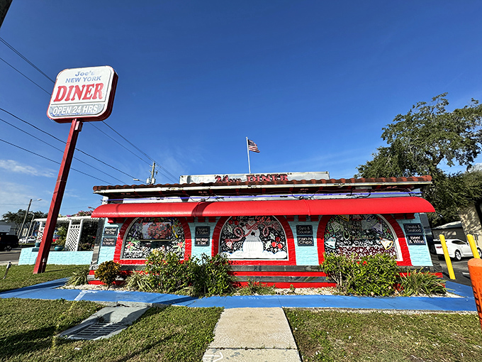 The blue exterior of Joe's New York Diner stands out like a beacon of hope for hungry travelers, promising comfort food with that unmistakable Florida-meets-Manhattan vibe.