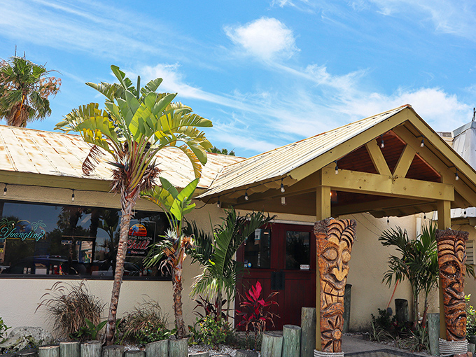 Tiki guardians flank the entrance to SeaBreeze Island Grill, promising tropical flavors and Florida vibes before you even step inside.