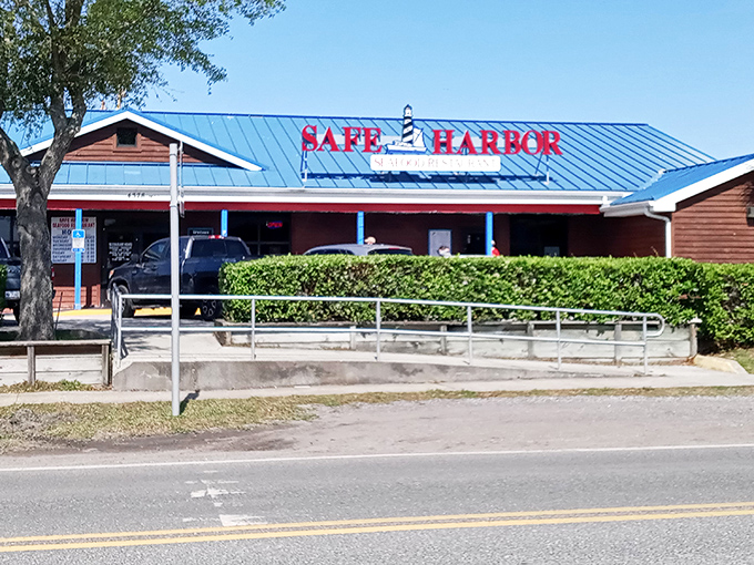 The bright blue roof of Safe Harbor beckons like a maritime lighthouse, promising seafood treasures within. Florida's coastal charm personified in weathered wood and nautical signage.